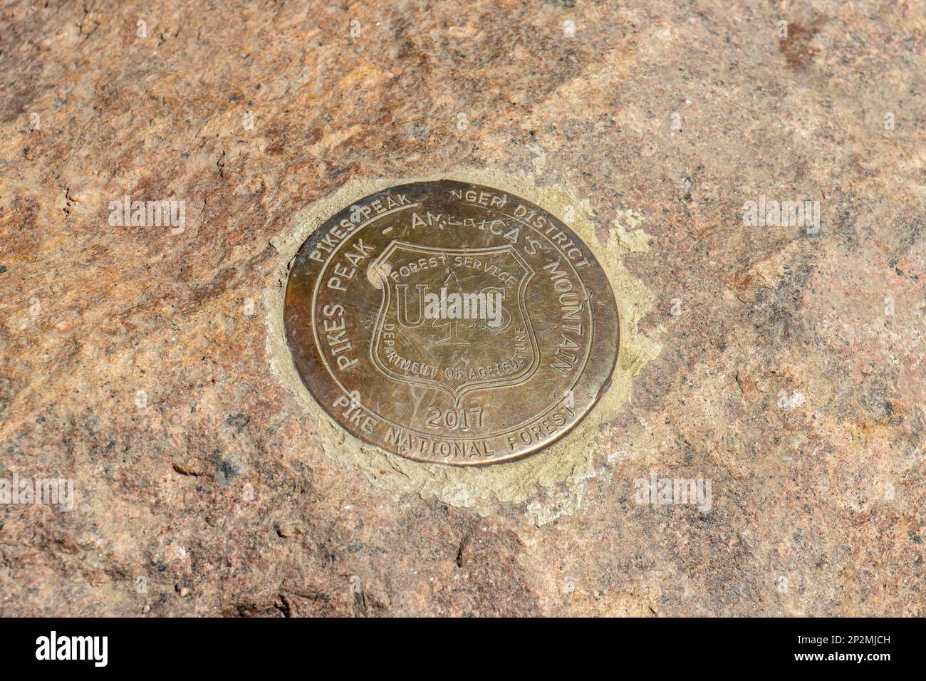 Plaque set in boulder marking the top of Pikes Peak in Colorado. USA ...