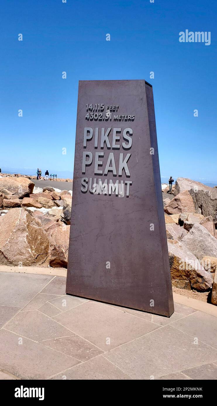 Sign at the top of Pikes Peak showing elevation. 14,115 feet. 4,302.31 ...