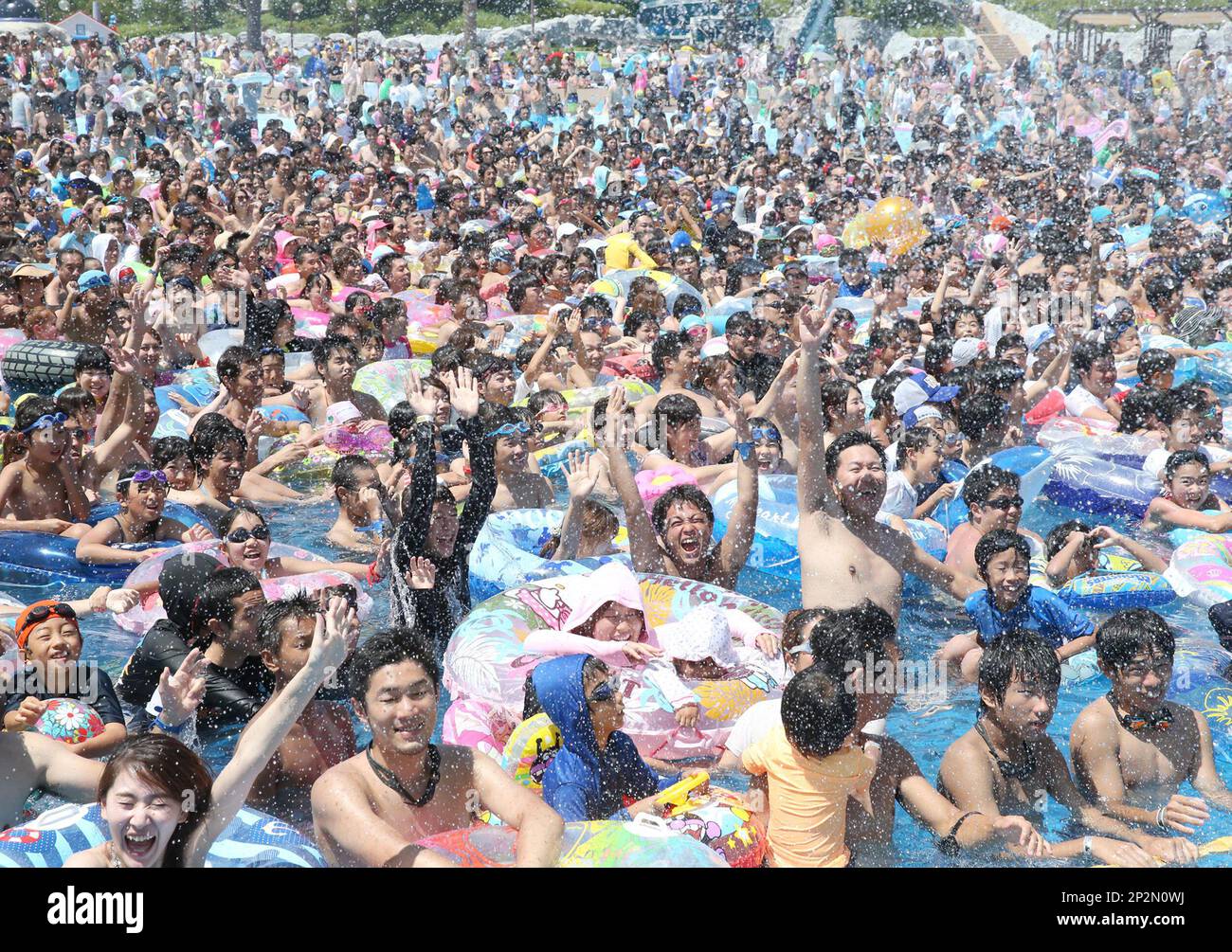 Swimming pools are crowded with people at Yomiuriland in Inagi, Tokyo ...