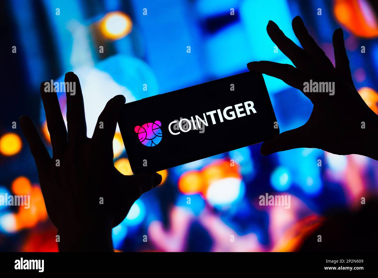 In this photo illustration, the CoinTiger logo seen displayed on a smartphone Stock Photo - Alamy