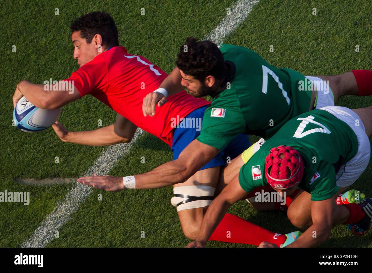 Chile's Francisco Hurtado, left, scores despite being brought down by ...