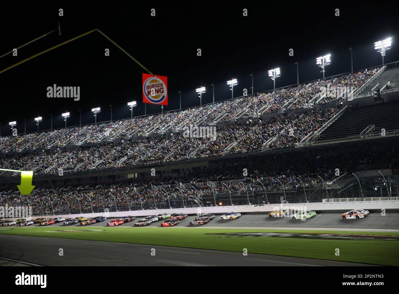 The pack of Sprint Cup race cars race into turn 1 during the 57th ...