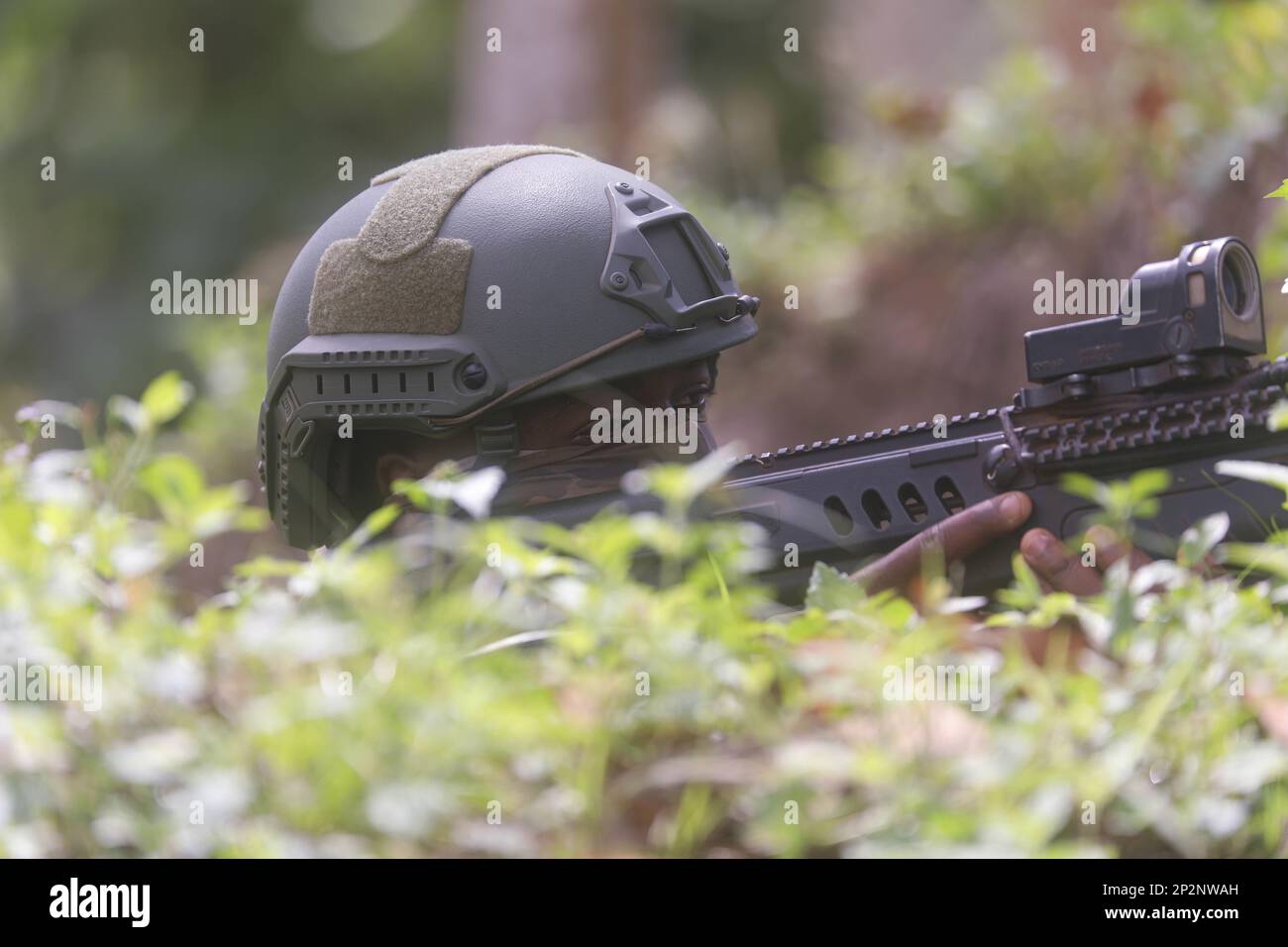 Ivorian Special Forces Soldier provides cover as team members clear a ...