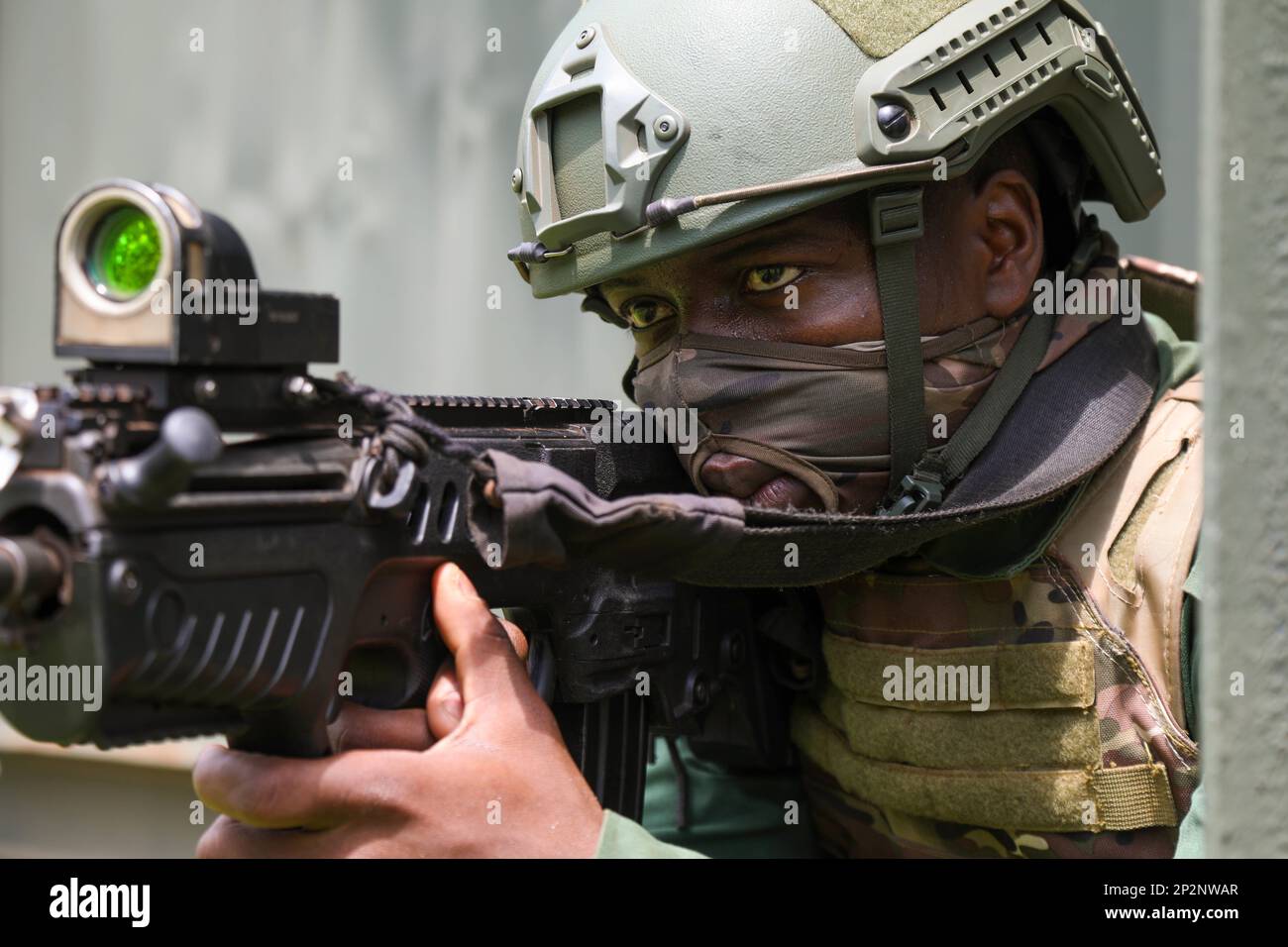 An Ivorian Special Forces Soldier provides cover as team members clear ...