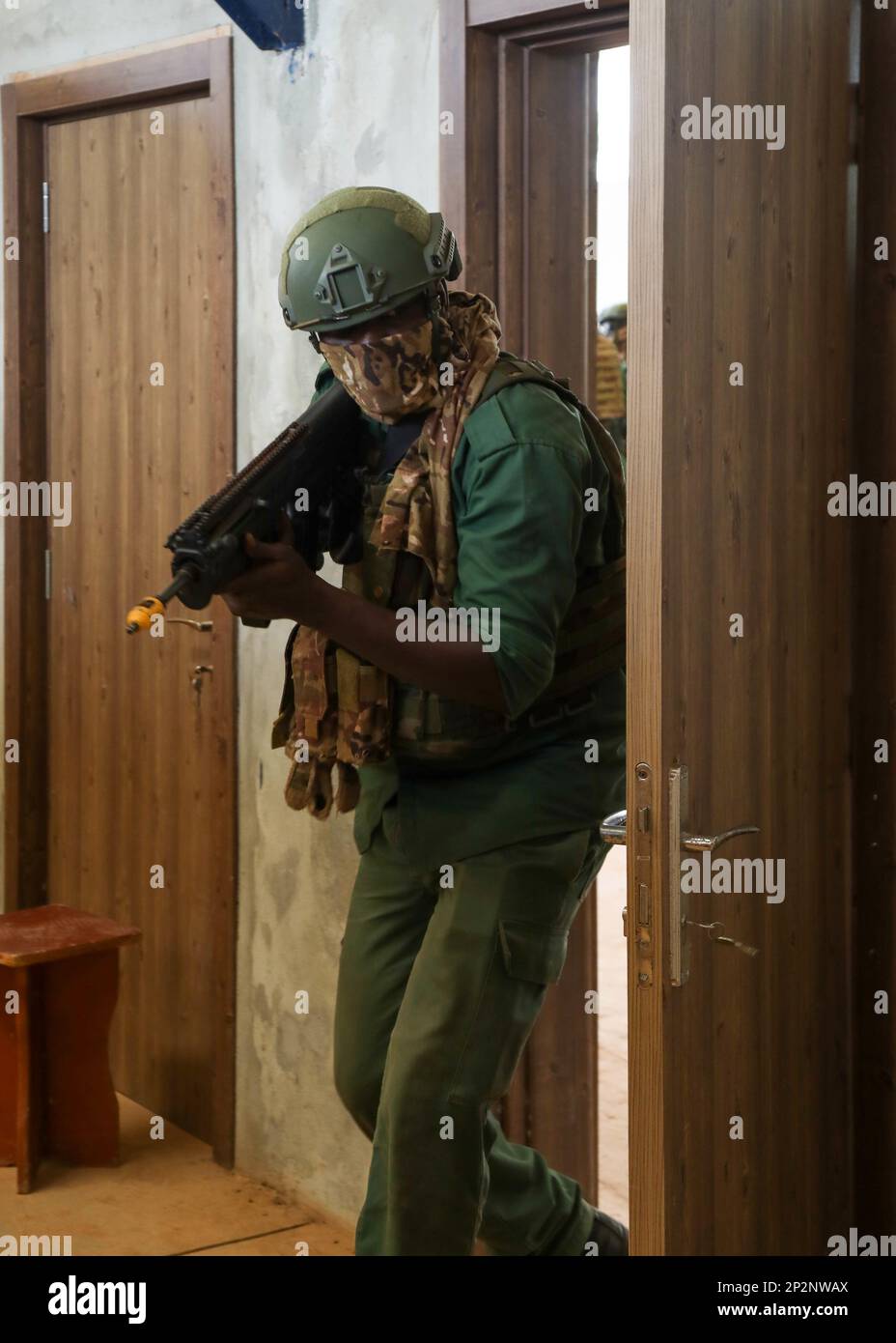 An Ivorian Special Forces Soldier keeps his weapon at a high ready as ...