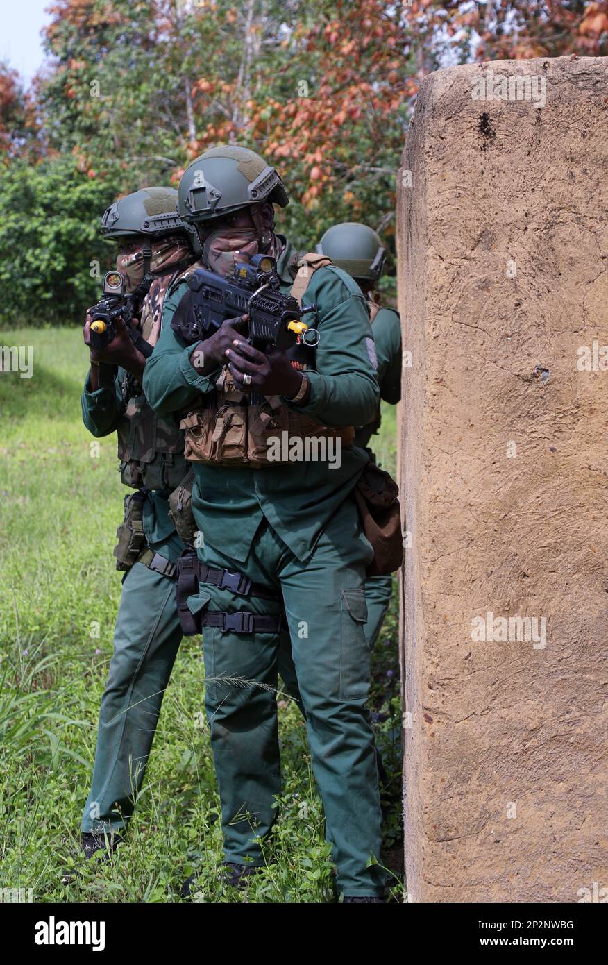 Ivorian Special Forces Soldiers execute tactical movements through a ...