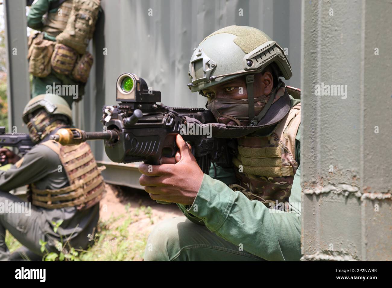 Ivorian Special Forces Soldiers provide cover as team members clear a ...