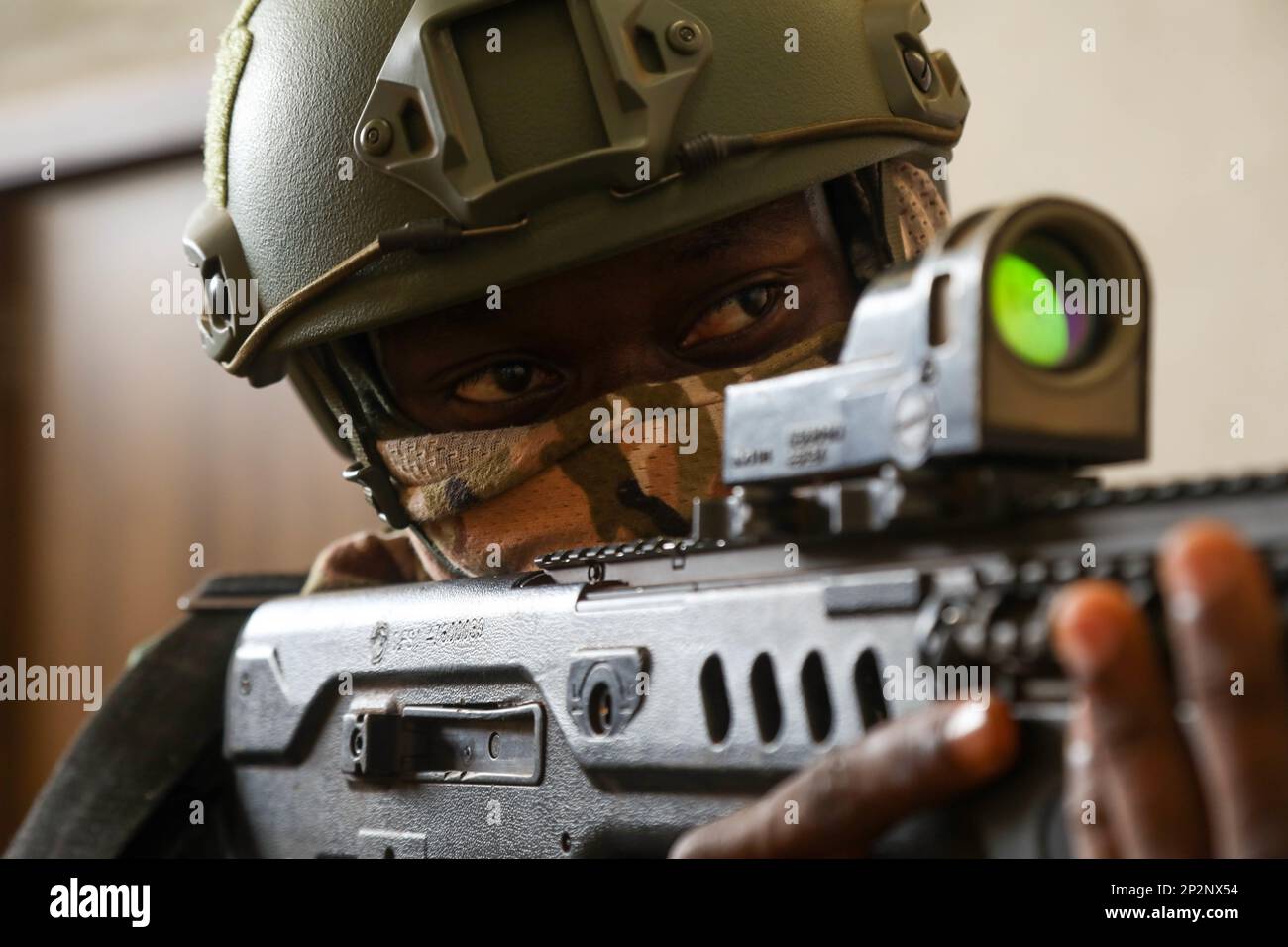 An Ivorian Special Forces Soldier keeps his weapon at a high ready ...