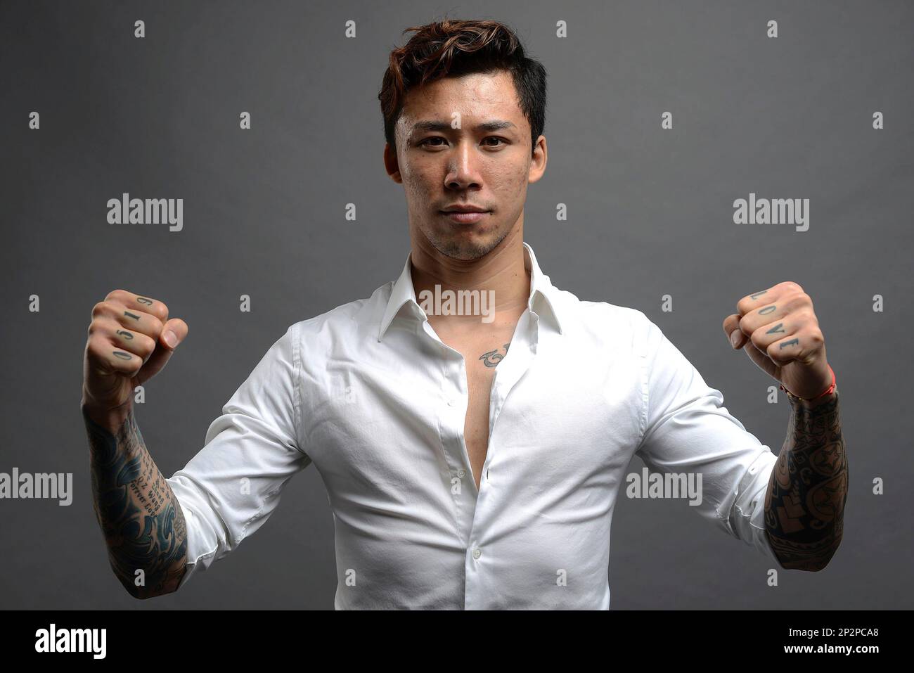 Chinese soccer star Zhang Linpeng poses for photos as he is elected as ...
