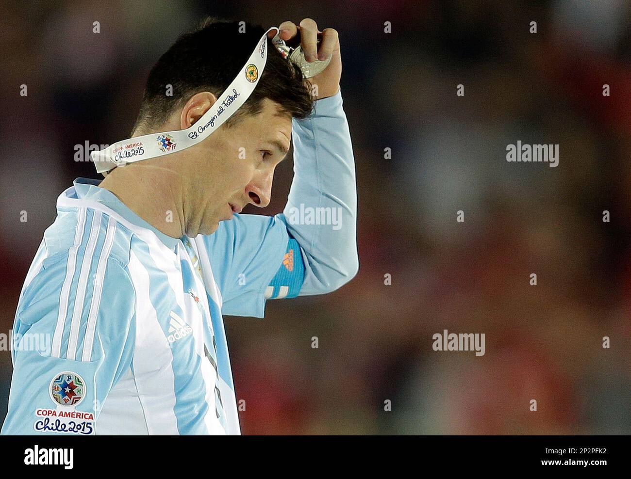 Argentina's Lionel Messi takes off the Copa America silver medal after ...