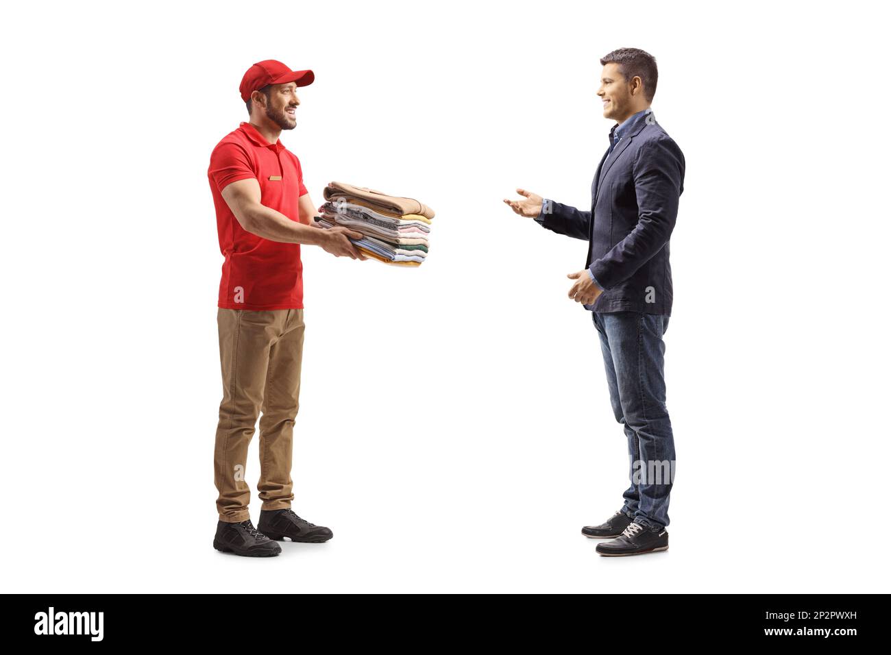 Delivery man giving a pile of folded clothes to a young man isolated on ...