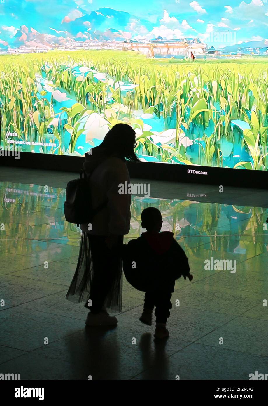 SHANGHAI, CHINA - MARCH 4, 2023 - Citizens pass a subway station's "light corridor", a painting ...