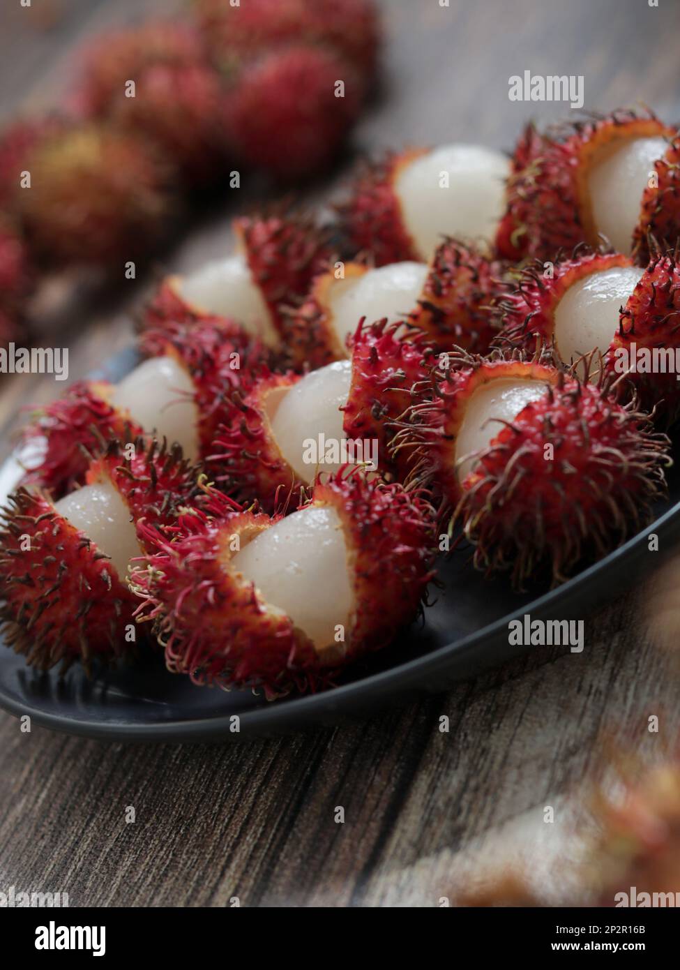 Delicious and sweet, Rambutan, tropical asia fruits, in black plate, on ...