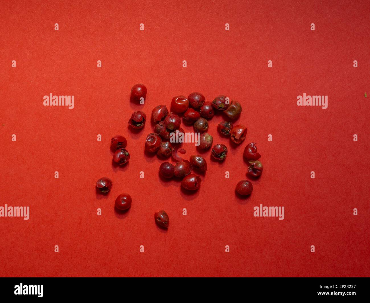 Red peppercorns on a red background. Red color. Seasoning for dishes ...