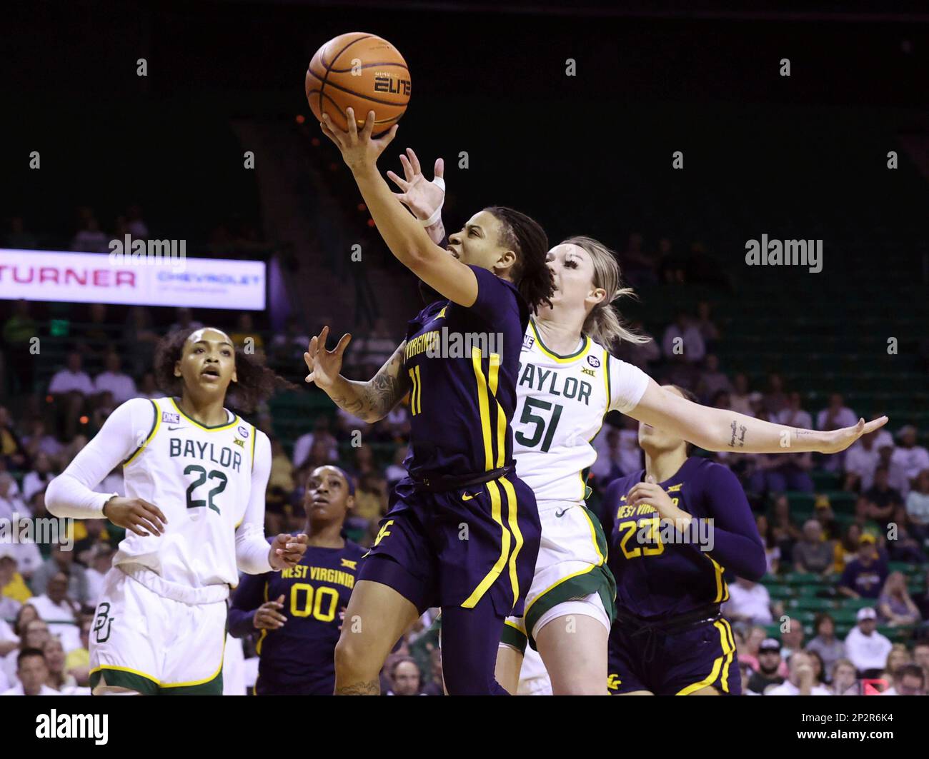West Virginia guard JJ Quinerly (11) attempts to score past Baylor ...