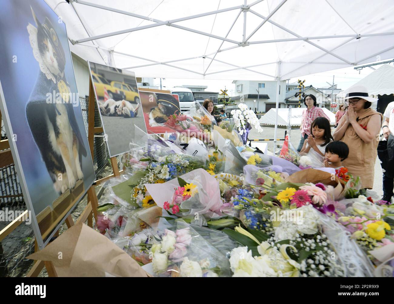 People pray in front of an altar especially set up for a funeral of ...