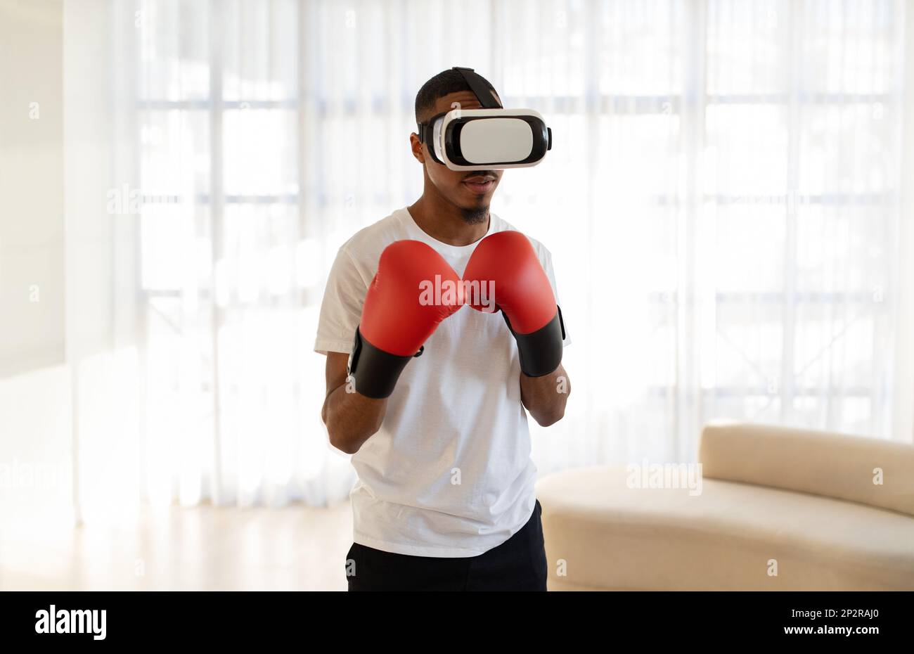 Black guy fighter in VR headset have boxing workout Stock Photo - Alamy