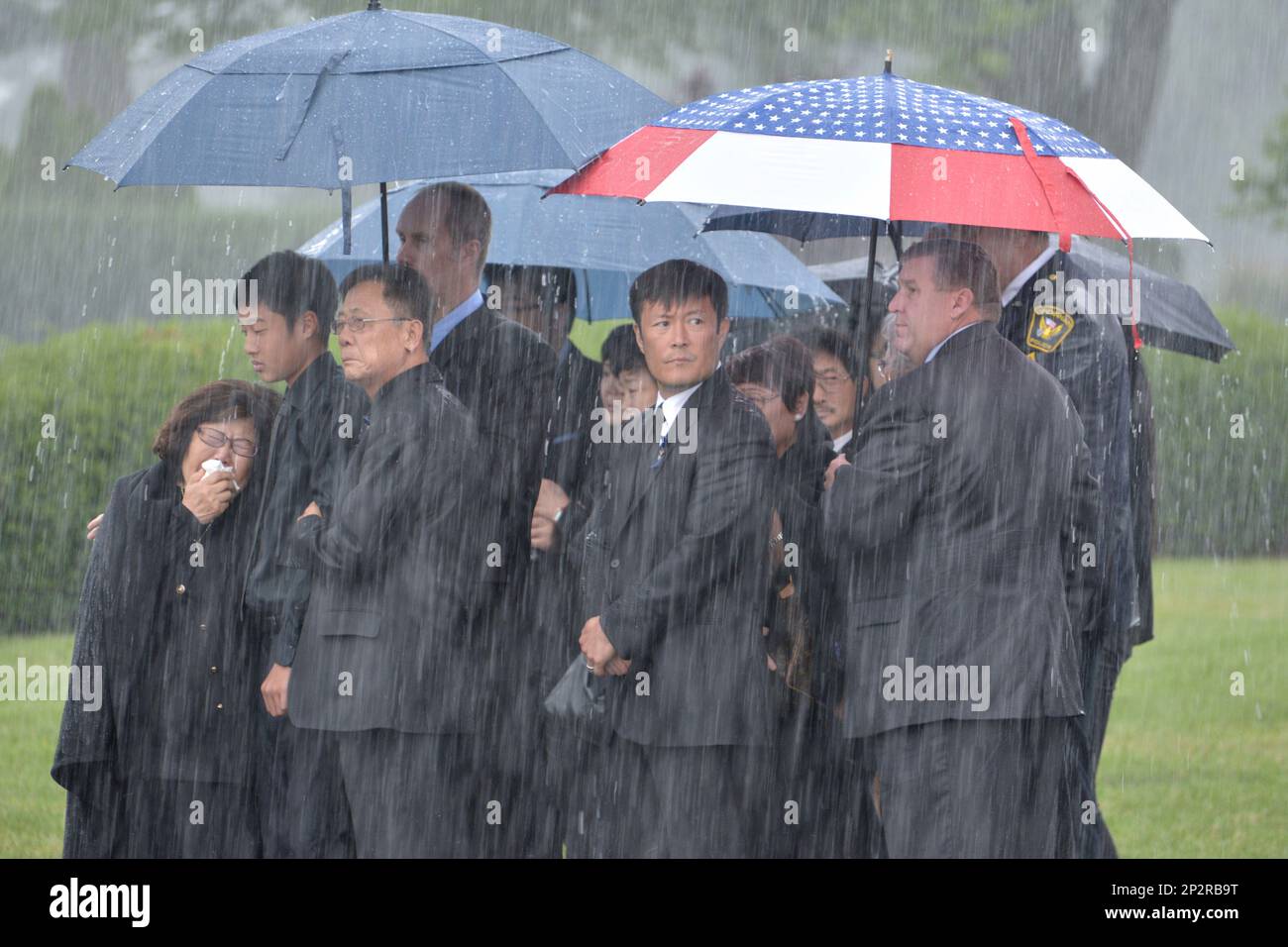 The family of slain Cincinnati Police Officer Sonny Kim stands in the ...