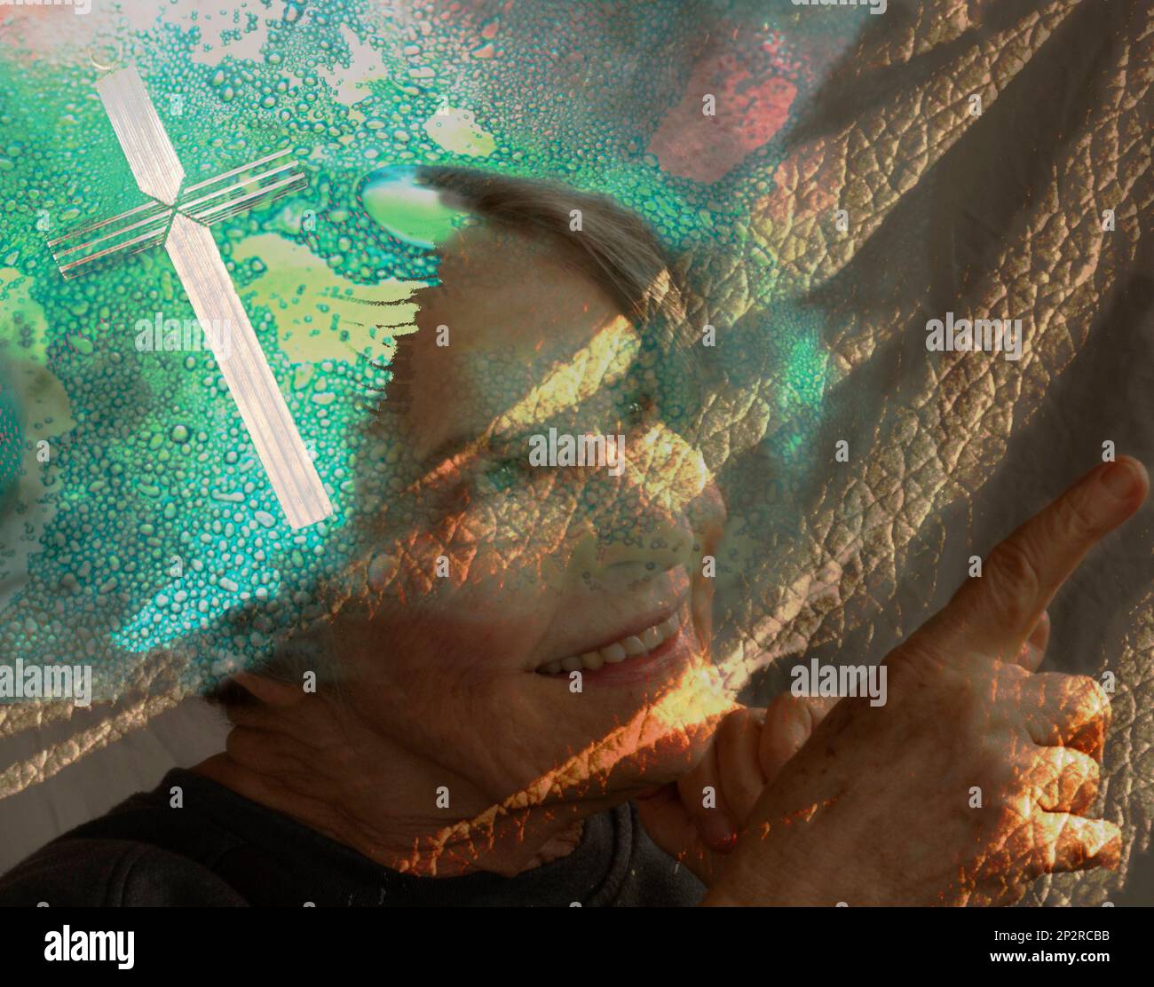 Mature woman smiling is pointing her finger upward to the heavens. A ...