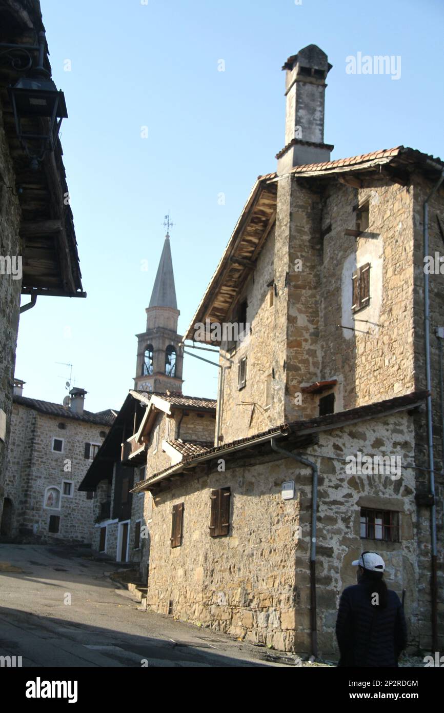 Street in the picturesque town of Frisanco, Italy, with stone houses ...