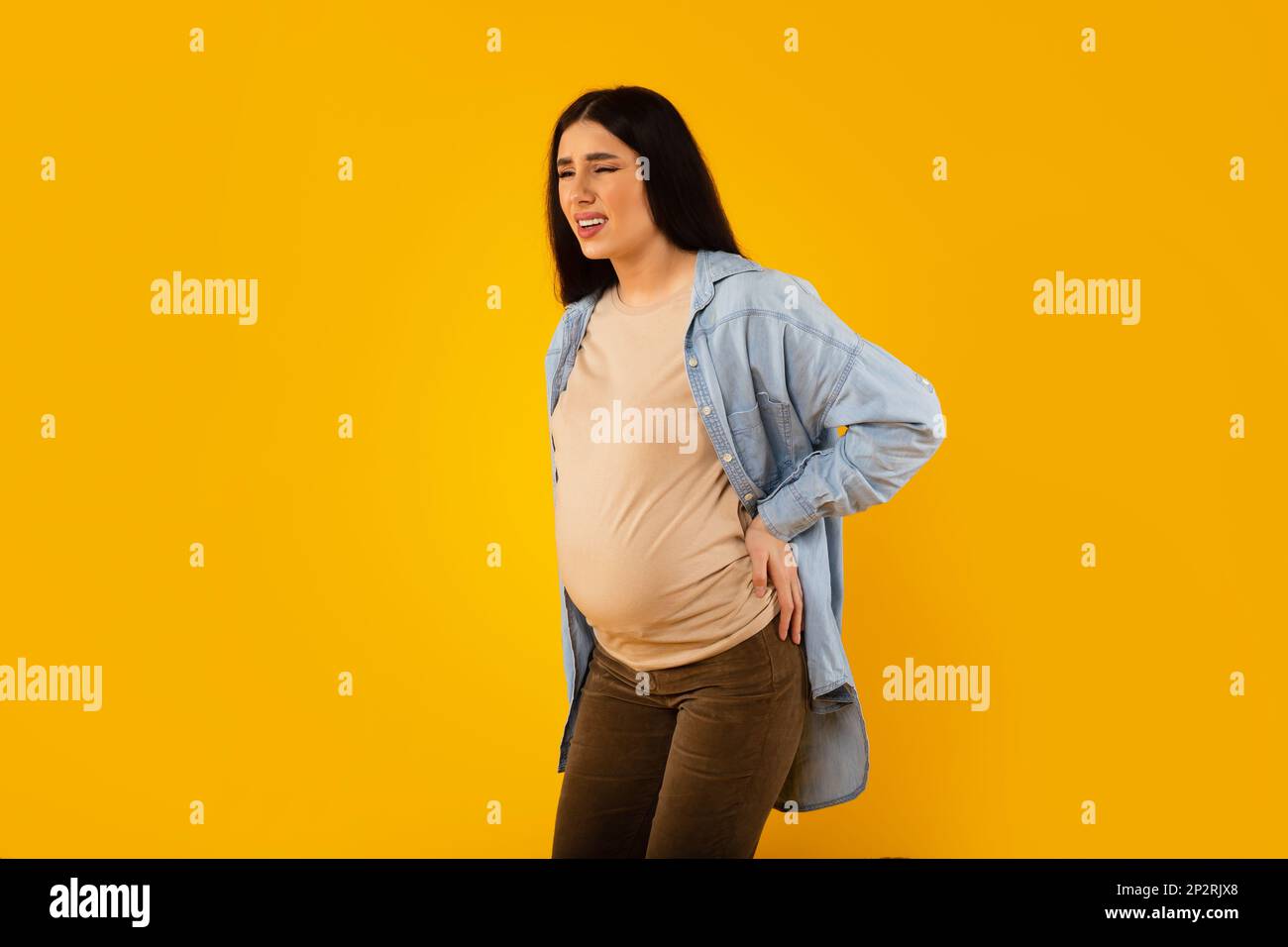 Pregnant woman suffering from pain, having spasm during painful ...