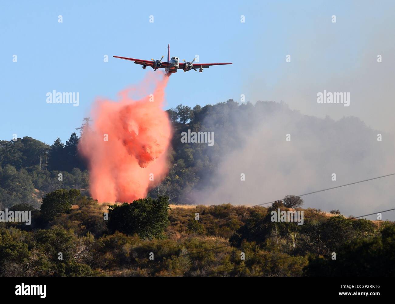 24 June 2015: A fixed wing aircraft makes a Phos-Chek drop on a ridge ...