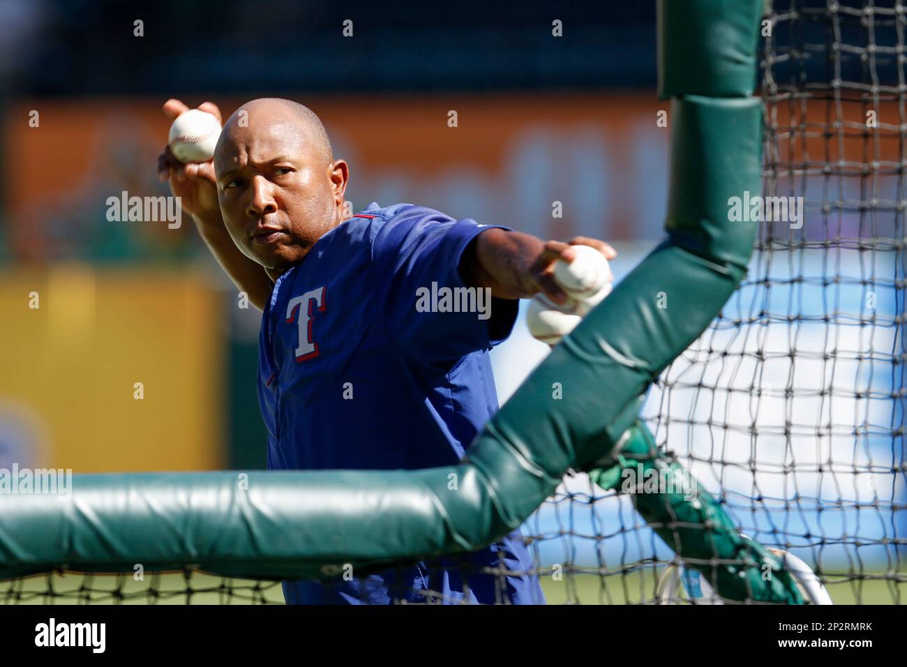 June 24, 2015: Texas Rangers third base coach Tony Beasley (27) throws ...