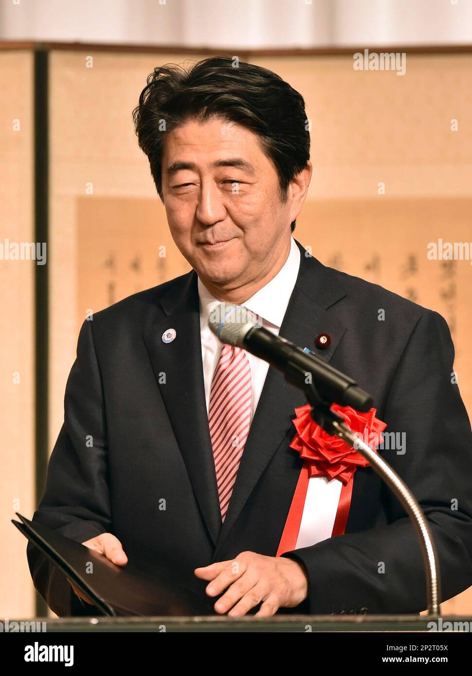 Japanese Prime Minister Shinzo Abe smiles as he delivers a speech at a ...