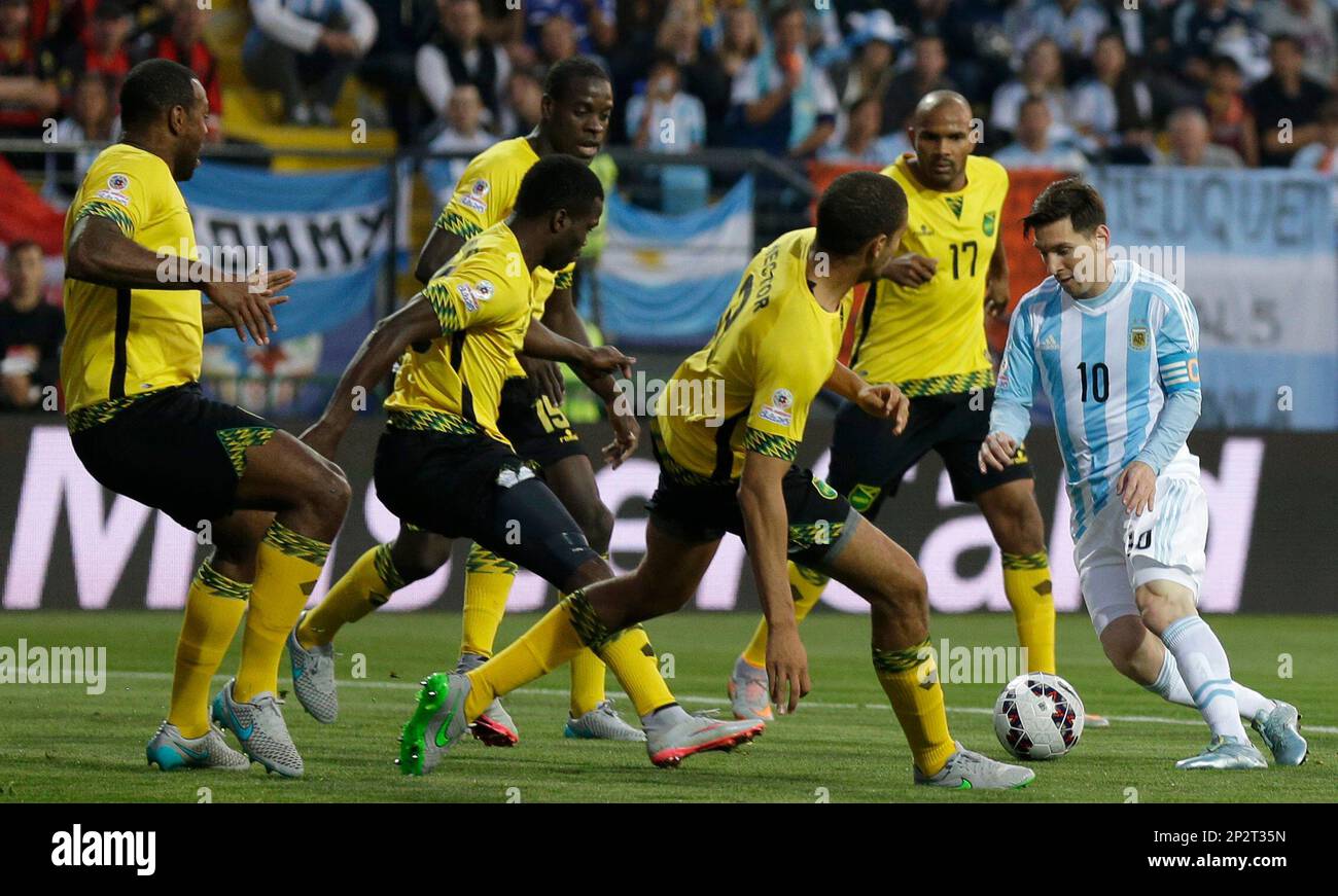 Surrounded by Jamaican players, Argentina's Lionel Messi controls the ...