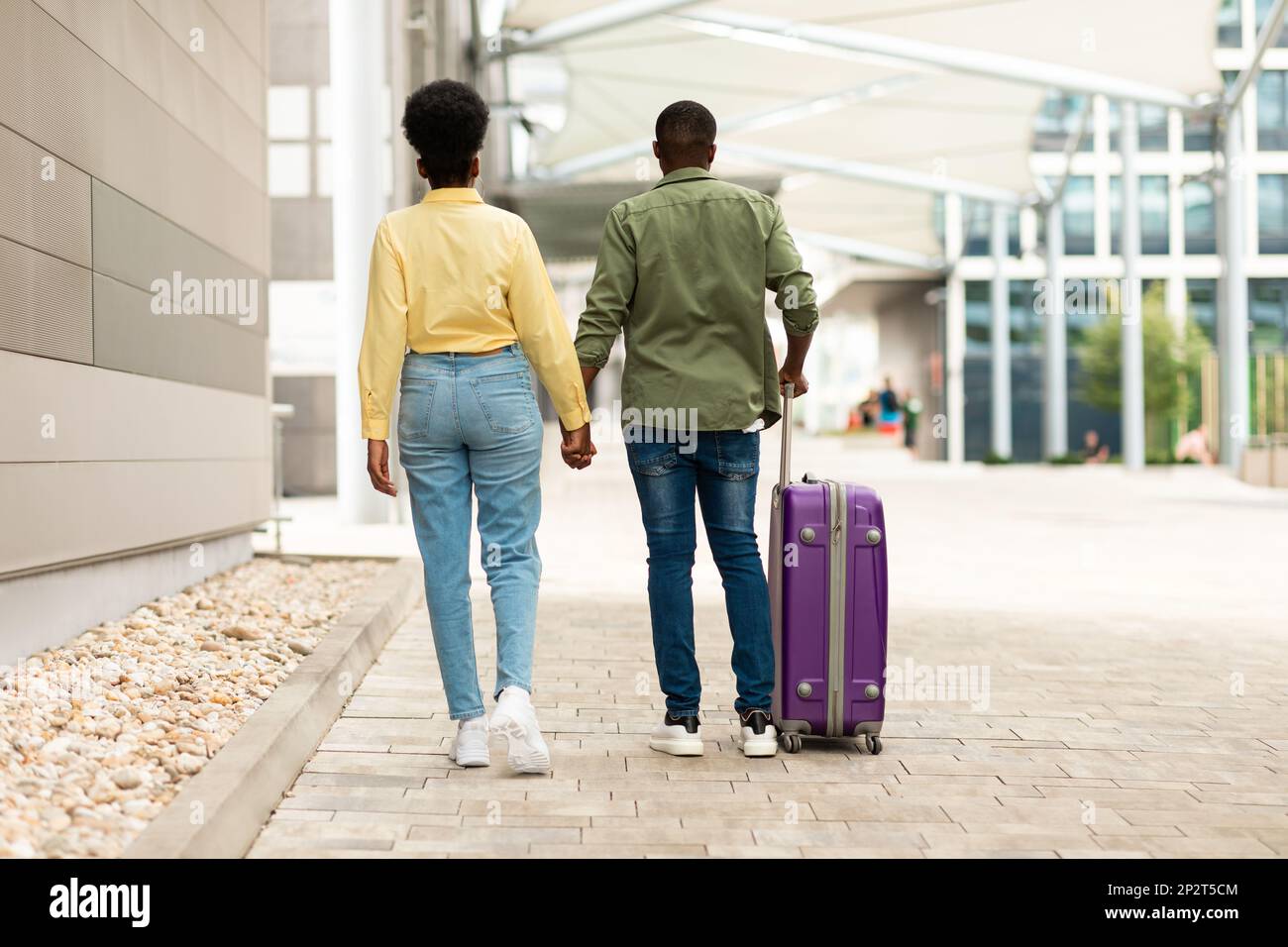 Black Couple Walking Holding Hands At Airport Outside, Back View Stock ...