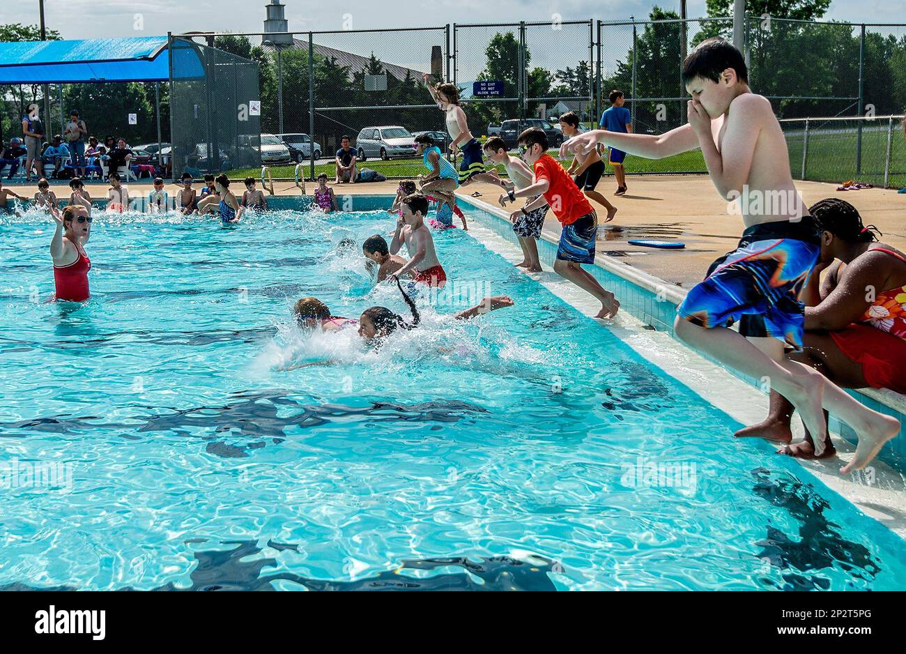 Childern learn how to properly jump into a pool in a lesson taught by ...