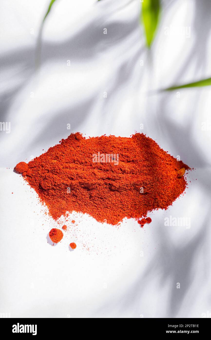 Bold and spicy: paprika powder on a white background with natural ...