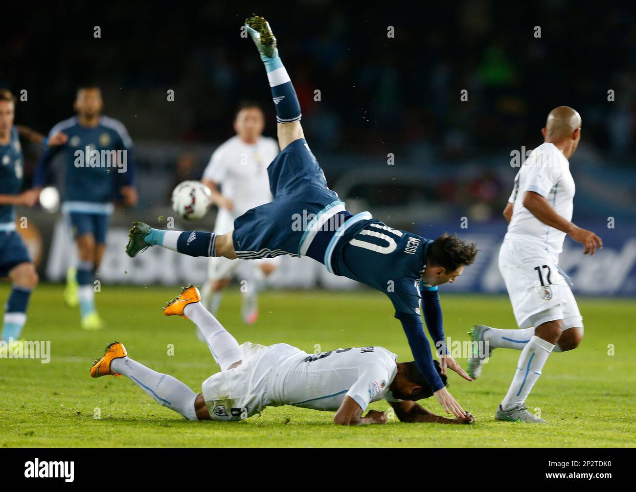Argentina's Lionel Messi falls on top of Uruguay's Alvaro Pereira ...