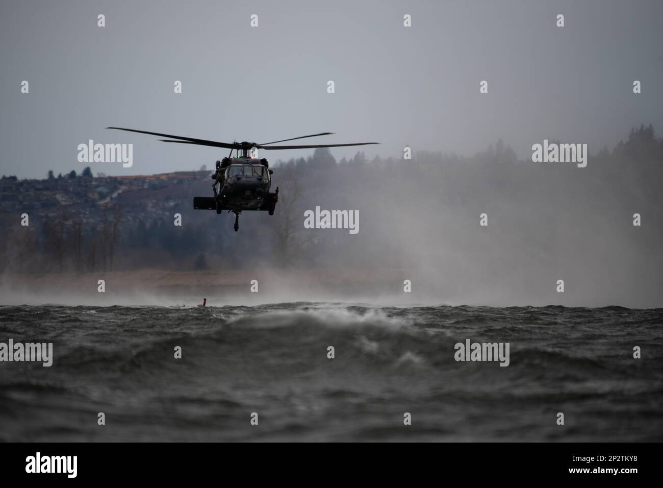 A 305th Rescue Squadron HH HH-60G Pave Hawk helicopter hovers over a ...