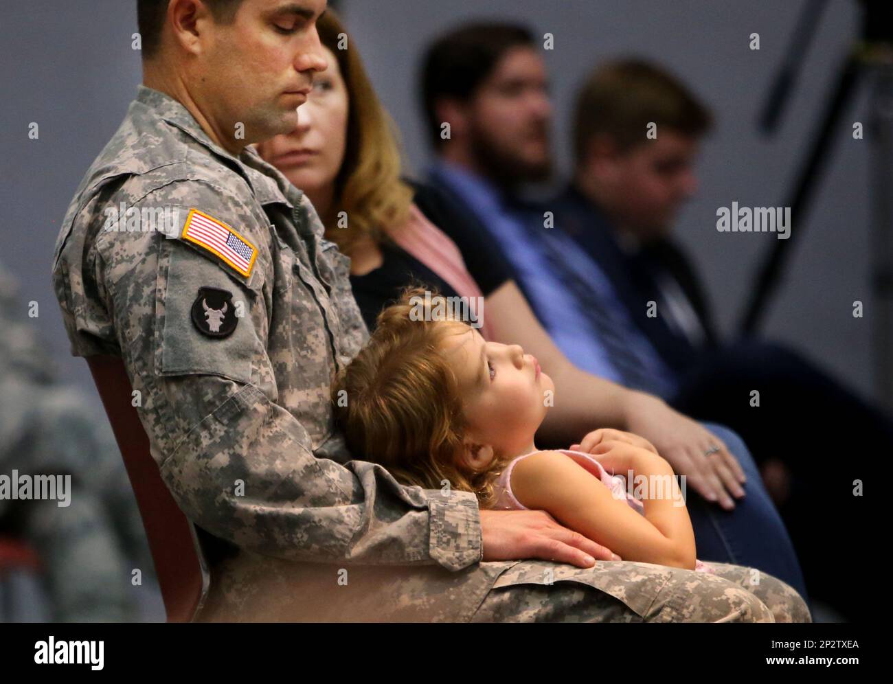 Staff Sgt. Aaron Jacobsen of Farmington holds his daughter Mollie, 4 ...