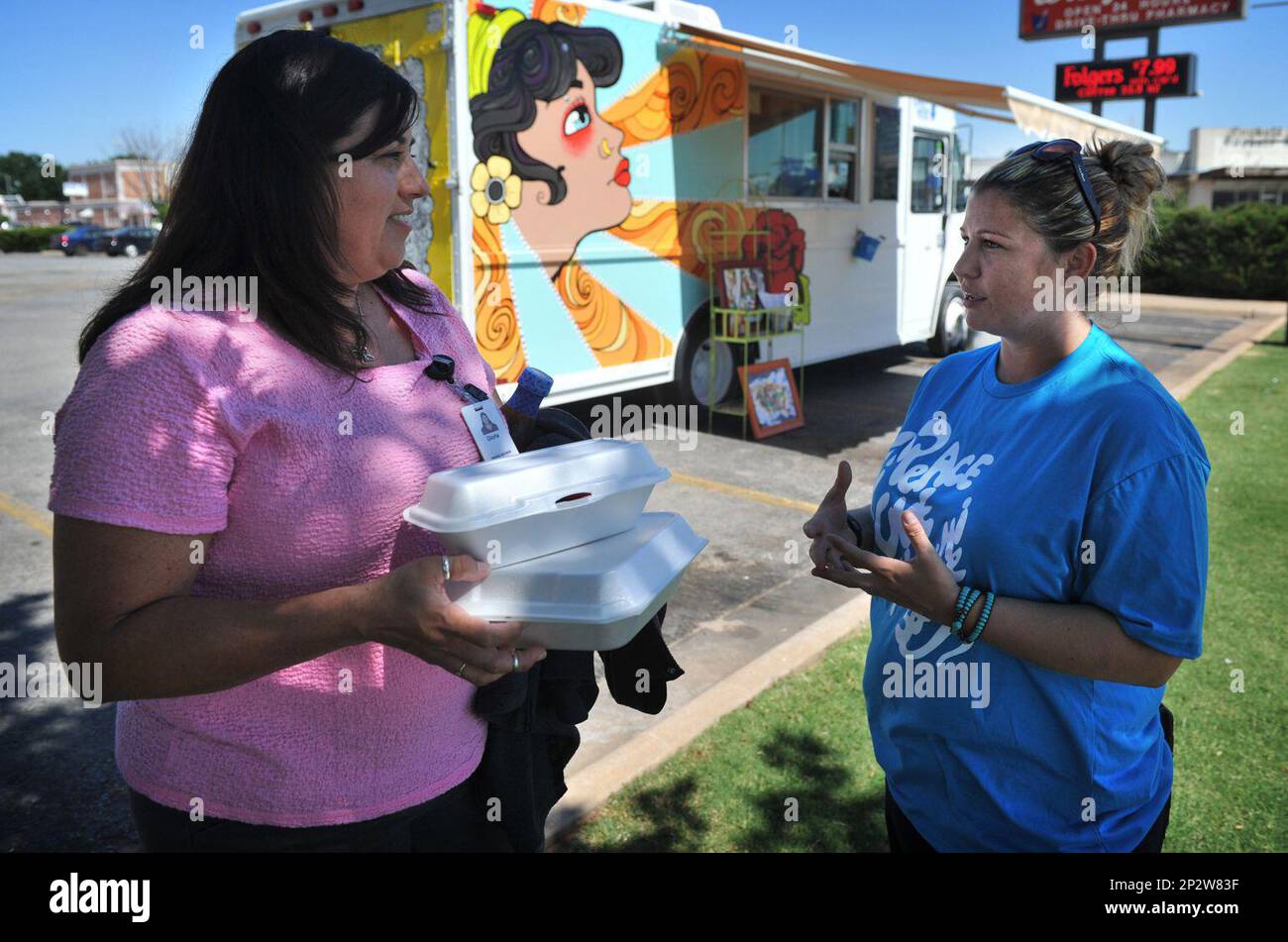 Tagan Couch, right, owner of The Gypsy Kit food truck, visits with ...