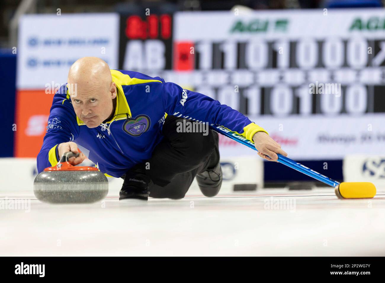 Team Alberta skip, Kevin Koe makes a shot against Team Nova Scotia ...