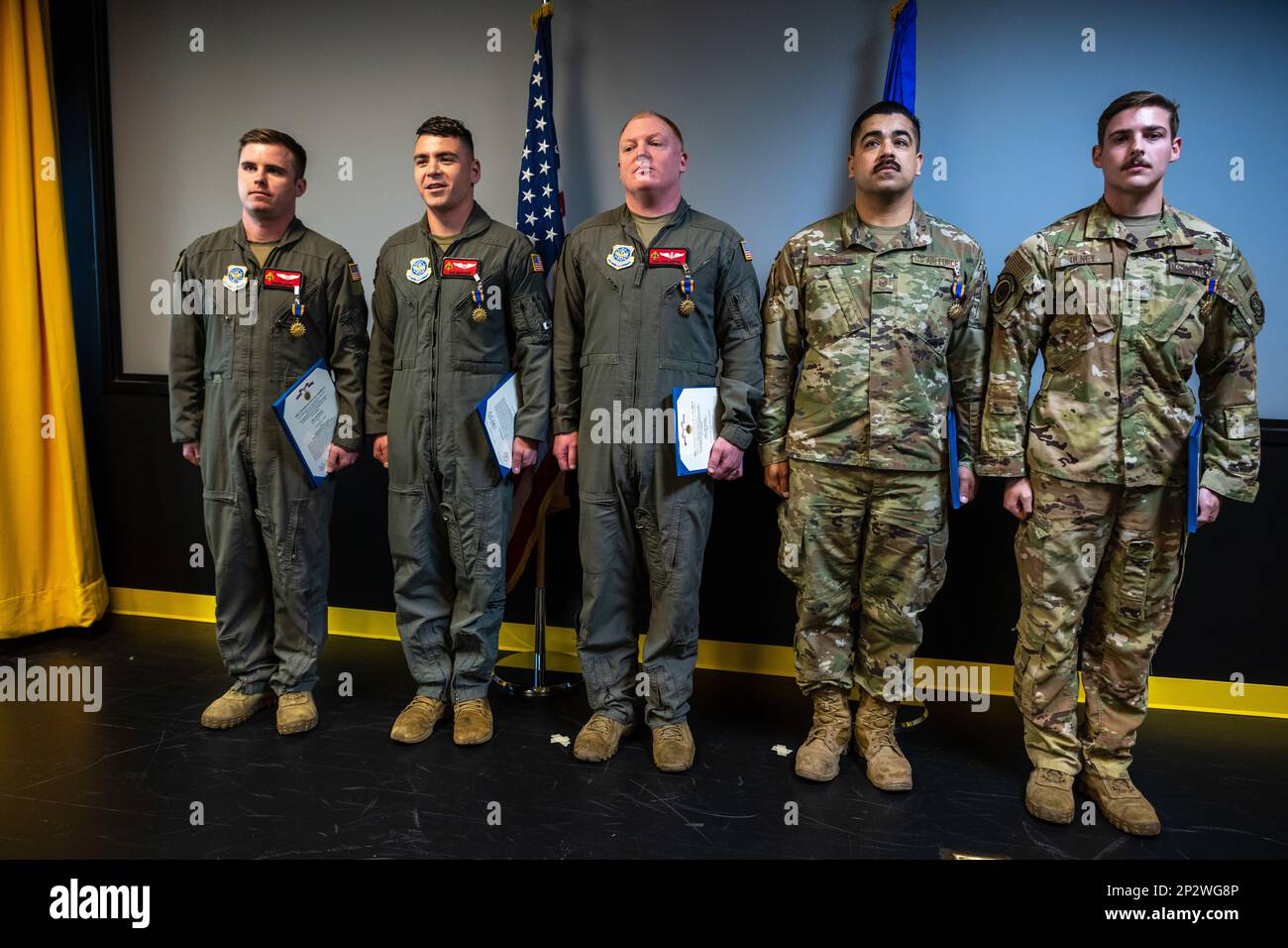 U.S. Airmen gather for a group photo holding their Air Medal citations ...