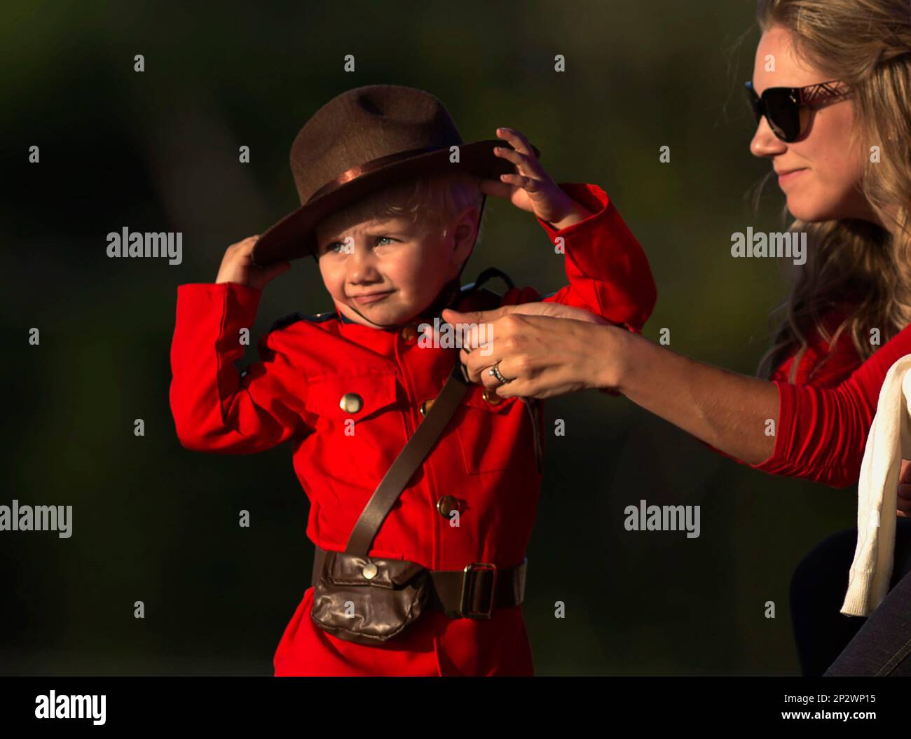 Austin Ross, young son of the late Const. Dave Ross, gets some help ...