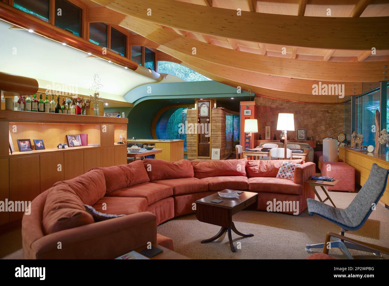 Curved laminated beams create a flowing ceiling in the the centerpiece ...