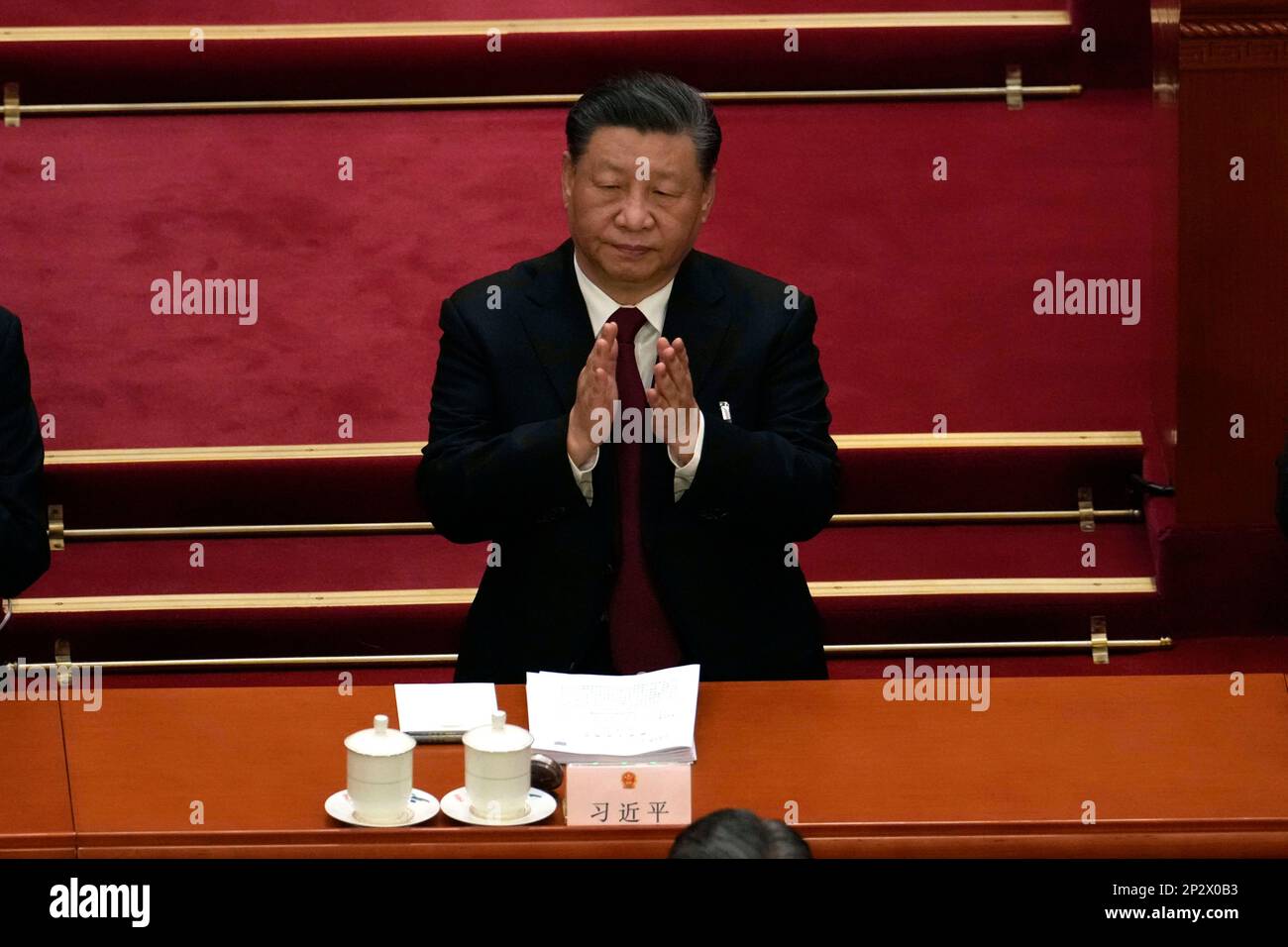 Chinese President Xi Jinping applauds during the opening session of ...