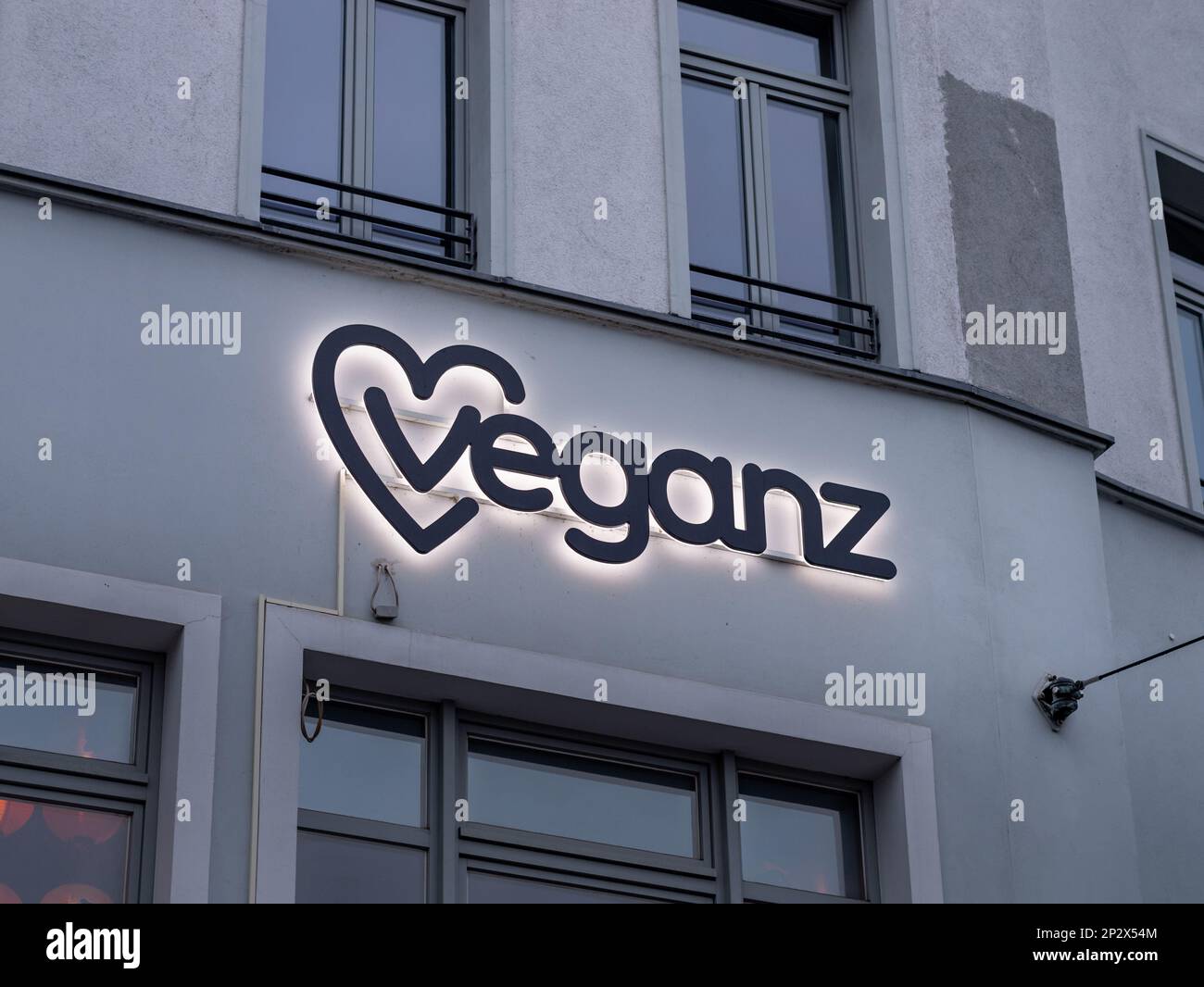 Veganz logo of the vegan only supermarket on a building. Illuminated ...