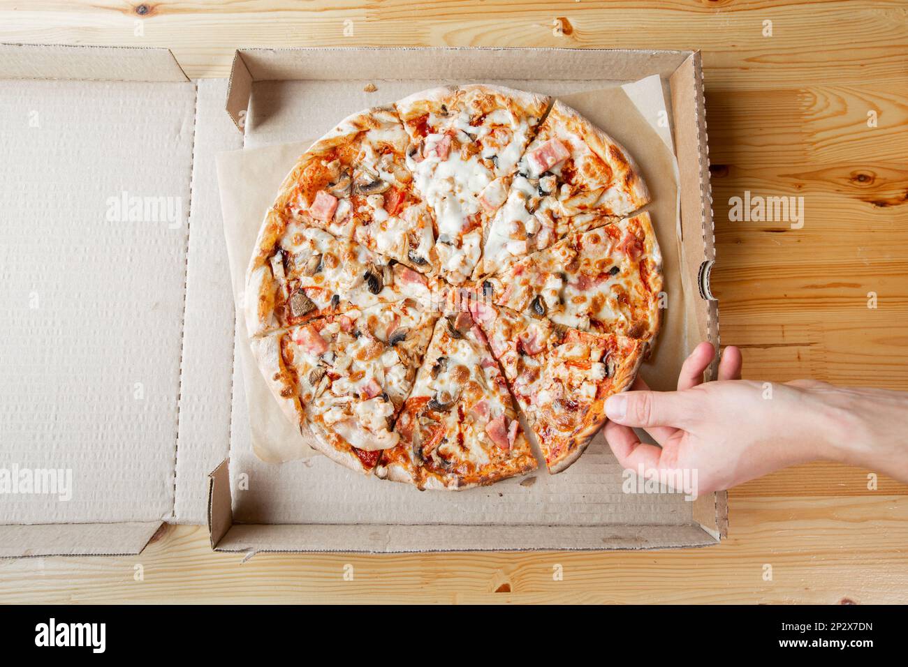 one people taking slices of pizza out of the box. fast delivery of food ...