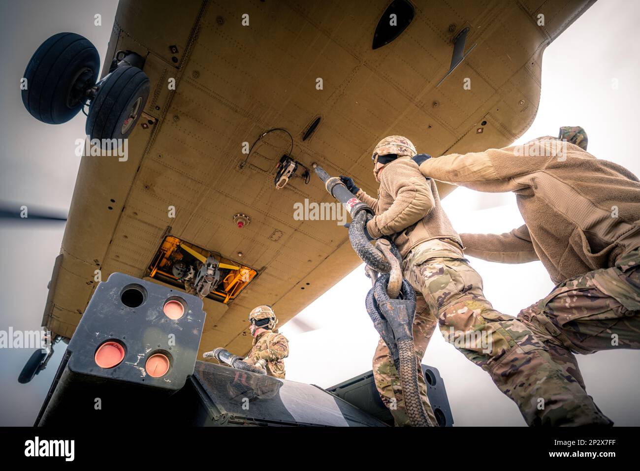 U.S. Army air defenders attach their Avenger weapon system to a Chinook ...