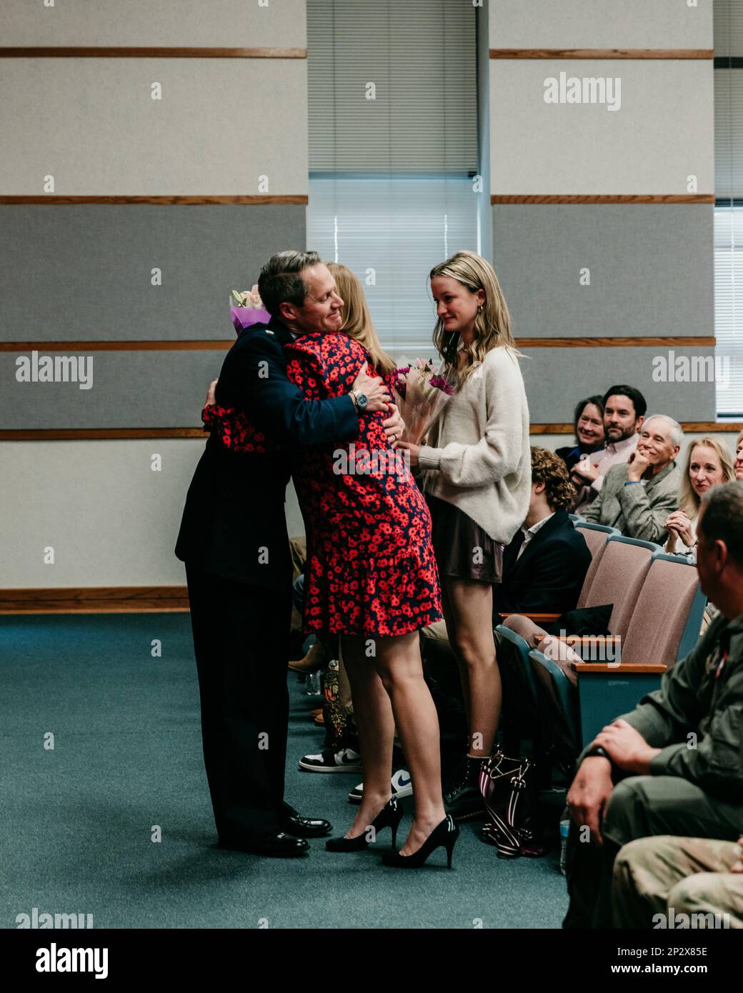 Lt. Col. Cade Keenan gifts flowers to wife during a change of command ...