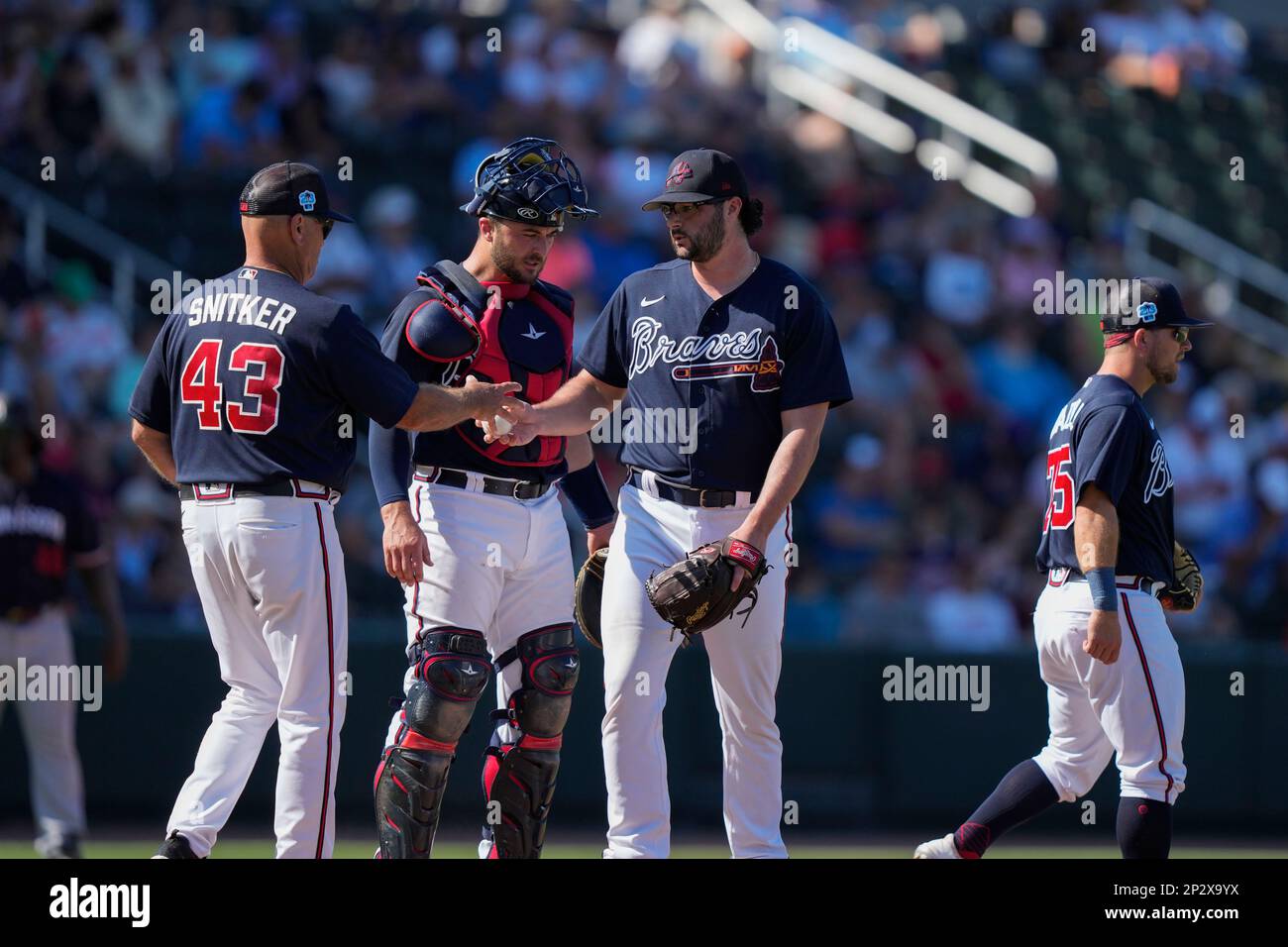 Atlanta Braves pitcher Joe Harvey (90) is pulled by manager Brian ...