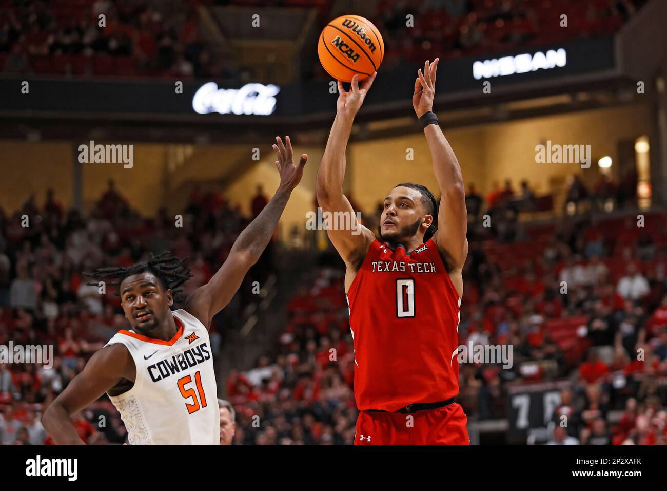 Texas Tech's Kevin Obanor (0) shoots over Oklahoma State's John-Michael ...