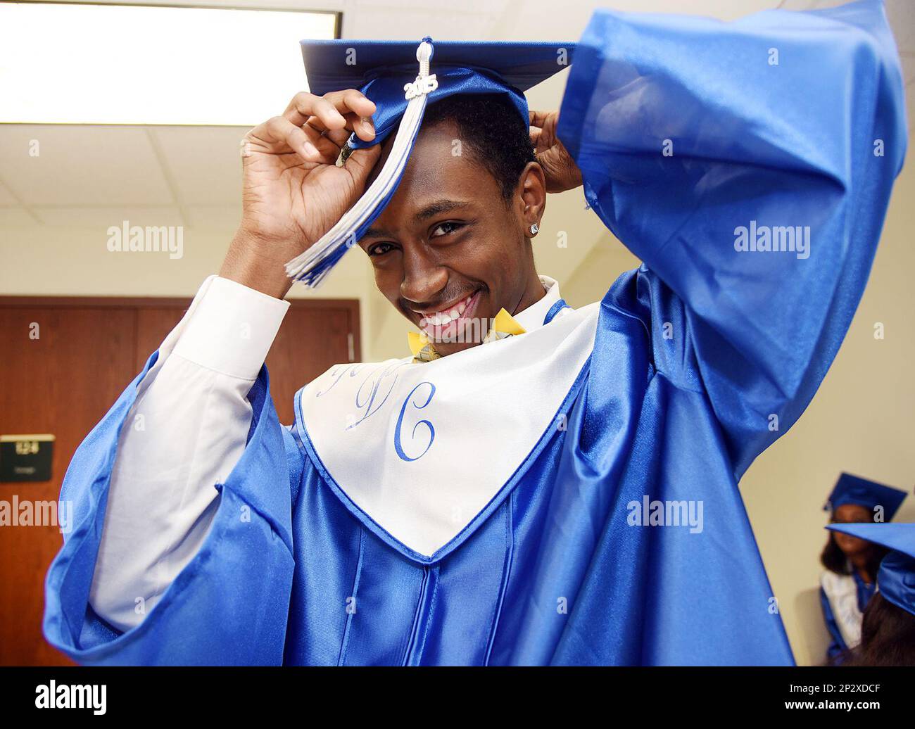 Michael Thompson makes final adjustments to his graduation cap at ...