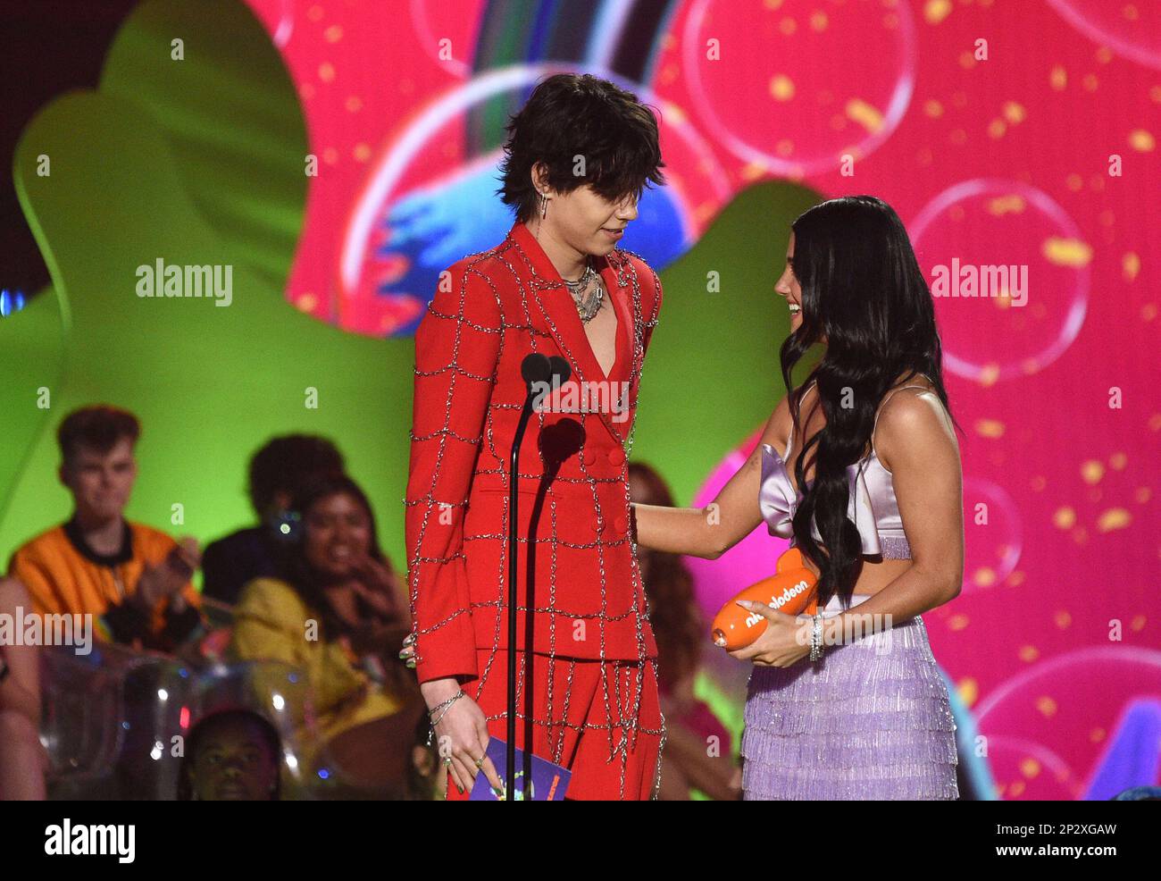 Landon Barker, left, presents the award for favorite female creator to Charli D'Amelio at the ...