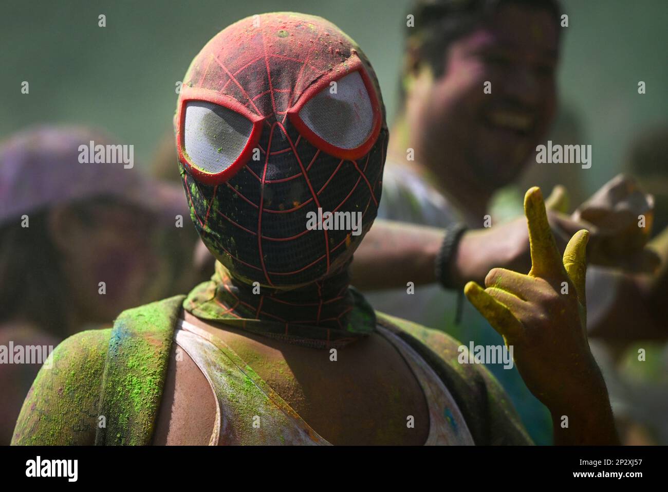A reveler dresses as Spiderman gestures during the celebration of the ...